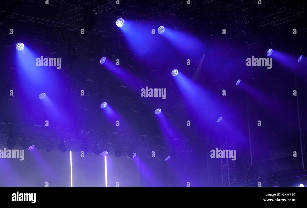Stage lights on electric concert on blue background Stock Photo - Alamy
