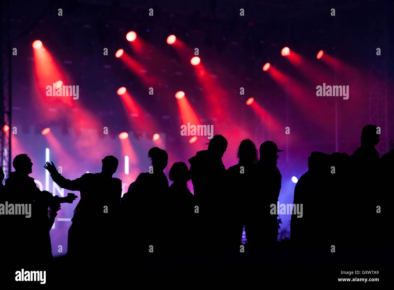 Cheering crowd in front of bright colorful stage lights Stock Photo - Alamy