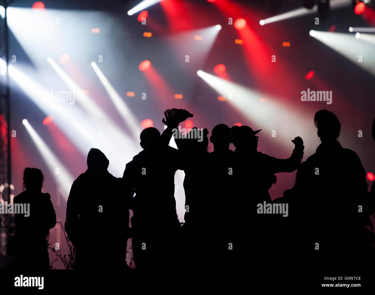 Cheering crowd in front of bright colorful stage lights Stock Photo - Alamy