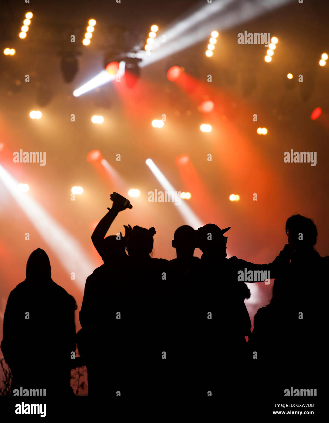 Cheering crowd in front of bright colorful stage lights Stock Photo - Alamy