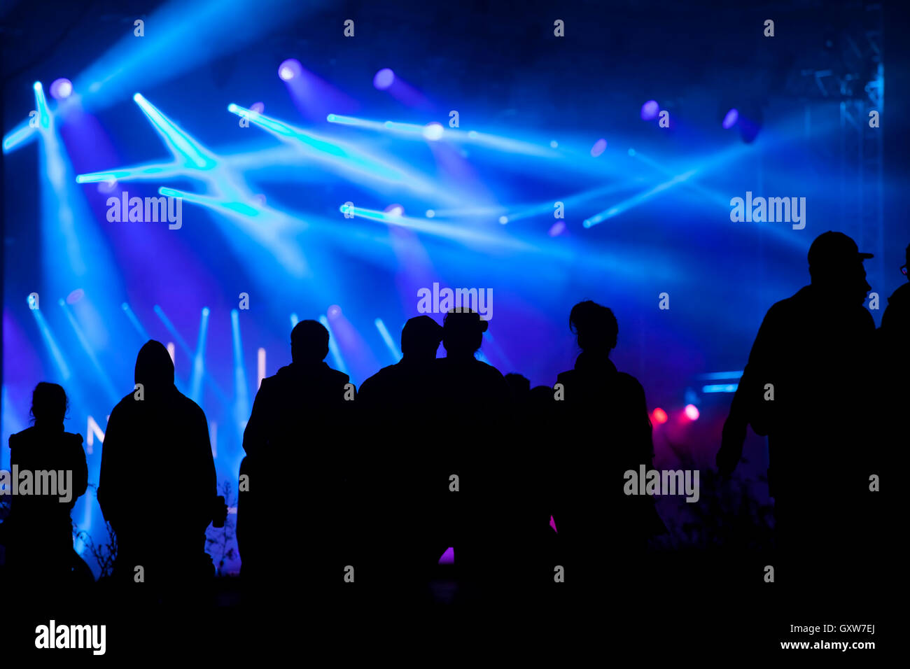 Cheering crowd in front of bright colorful stage lights Stock Photo - Alamy