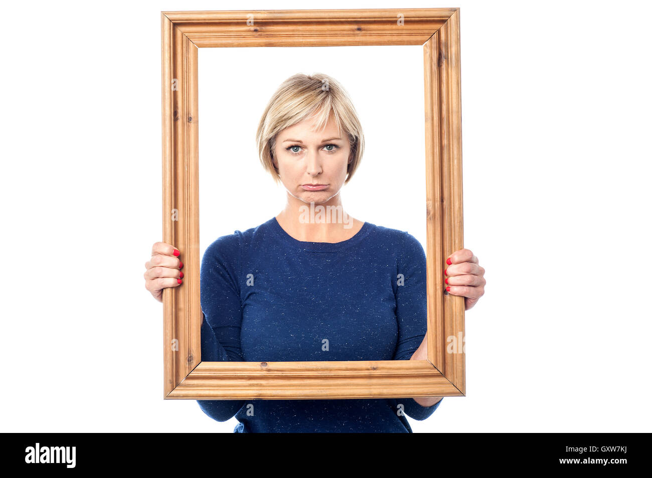 Sad woman holding picture frame Stock Photo - Alamy