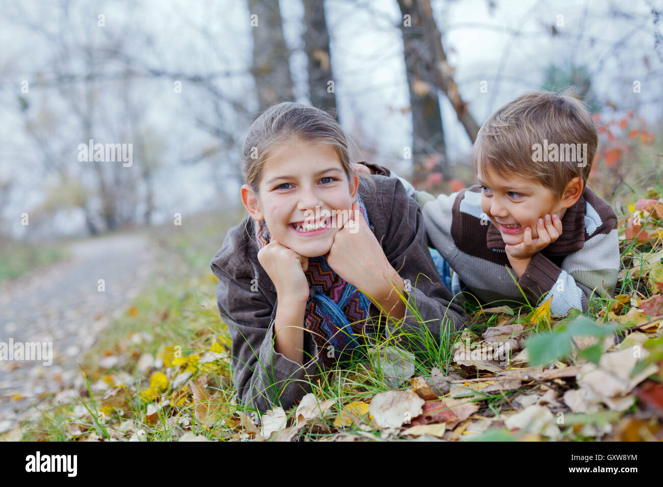 Kids in autumn park Stock Photo - Alamy
