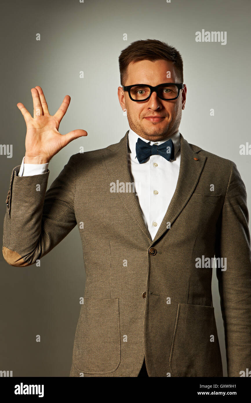 Nerd in eyeglasses and bow tie says Hello Stock Photo - Alamy