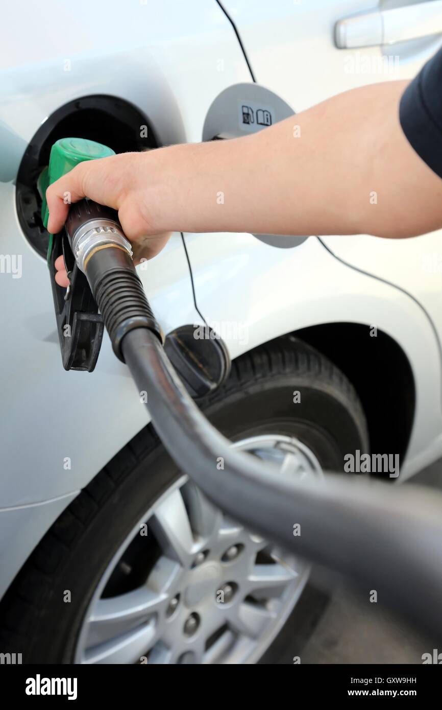 Gas Station Refill Hand and Nozzle Stock Photo - Alamy