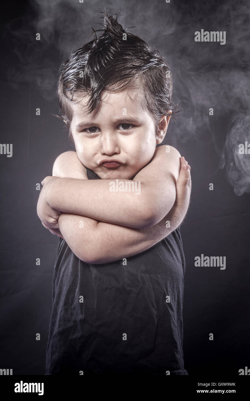 Angry, child rocker dress and funny expressions crested Stock Photo - Alamy