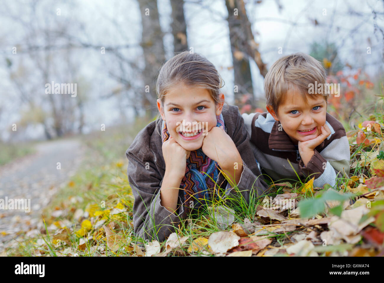Kids in autumn park Stock Photo - Alamy