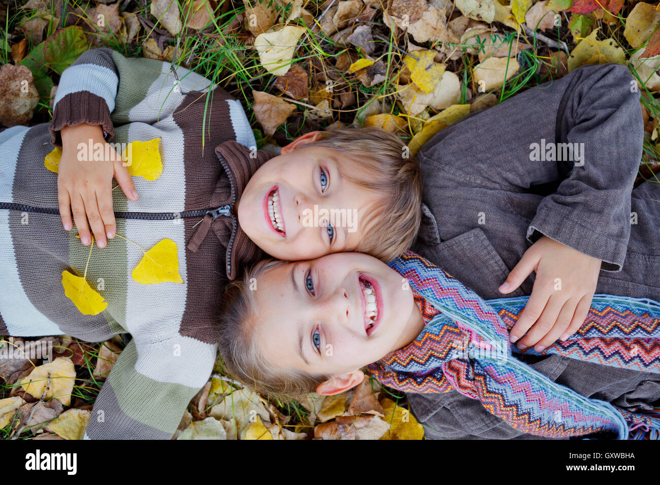 Kids in autumn park Stock Photo - Alamy
