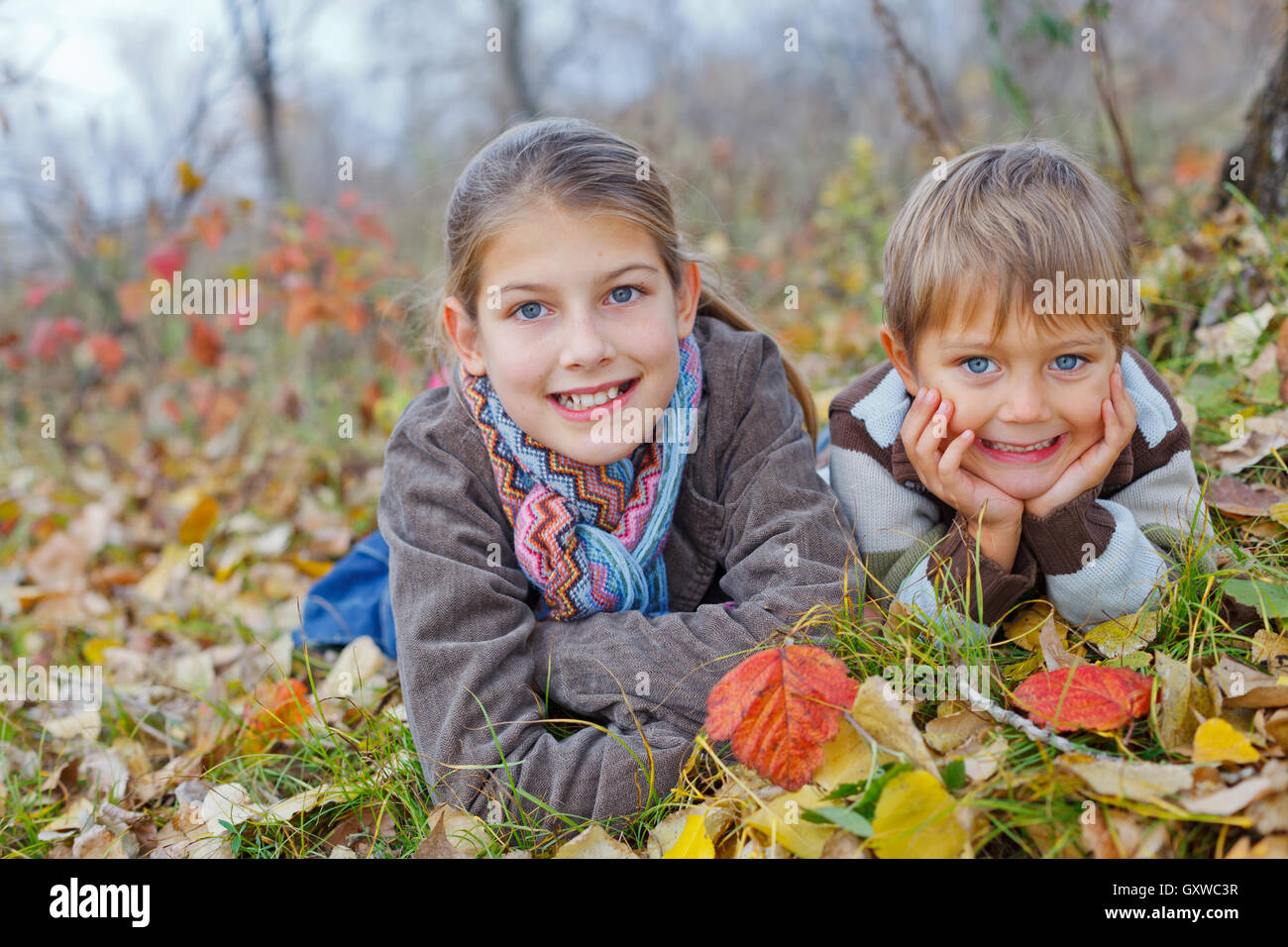 Kids in autumn park Stock Photo - Alamy