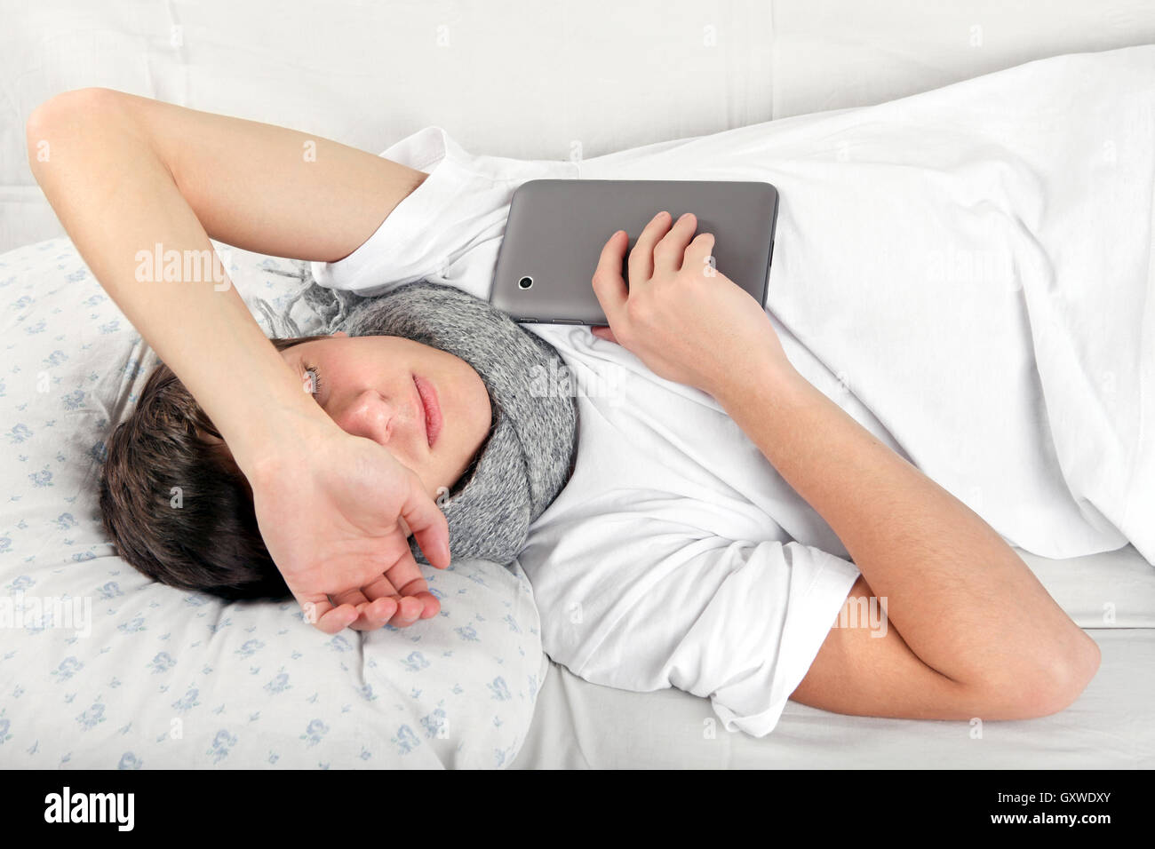 Sick Teenager with Tablet Stock Photo - Alamy