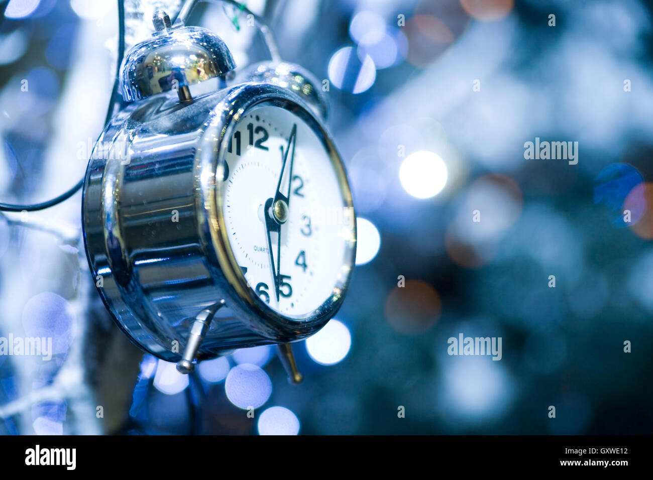 metal clock on a holiday background with sparkles and highlights Stock ...