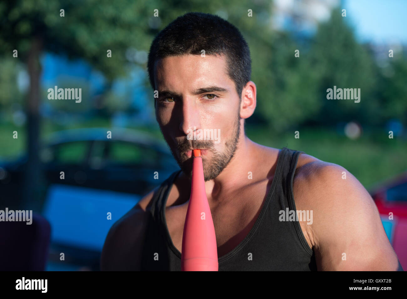 Young Man Smoking Shisha Outdoors - Man Exhaling Smoke Inhaling From A ...