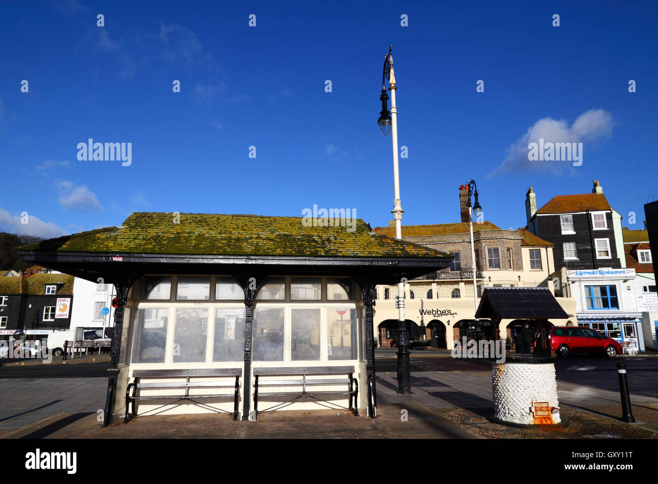 Old fashioned bus shelter and wishing well on sea front on Old Town ...