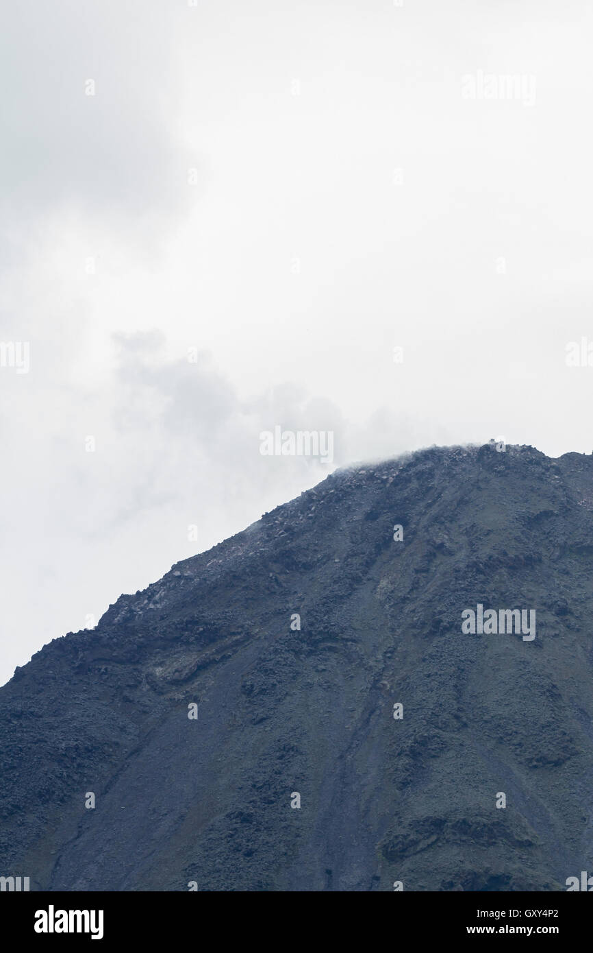 Close up of the top of the cone of the Volcan Arenal with steam coming ...