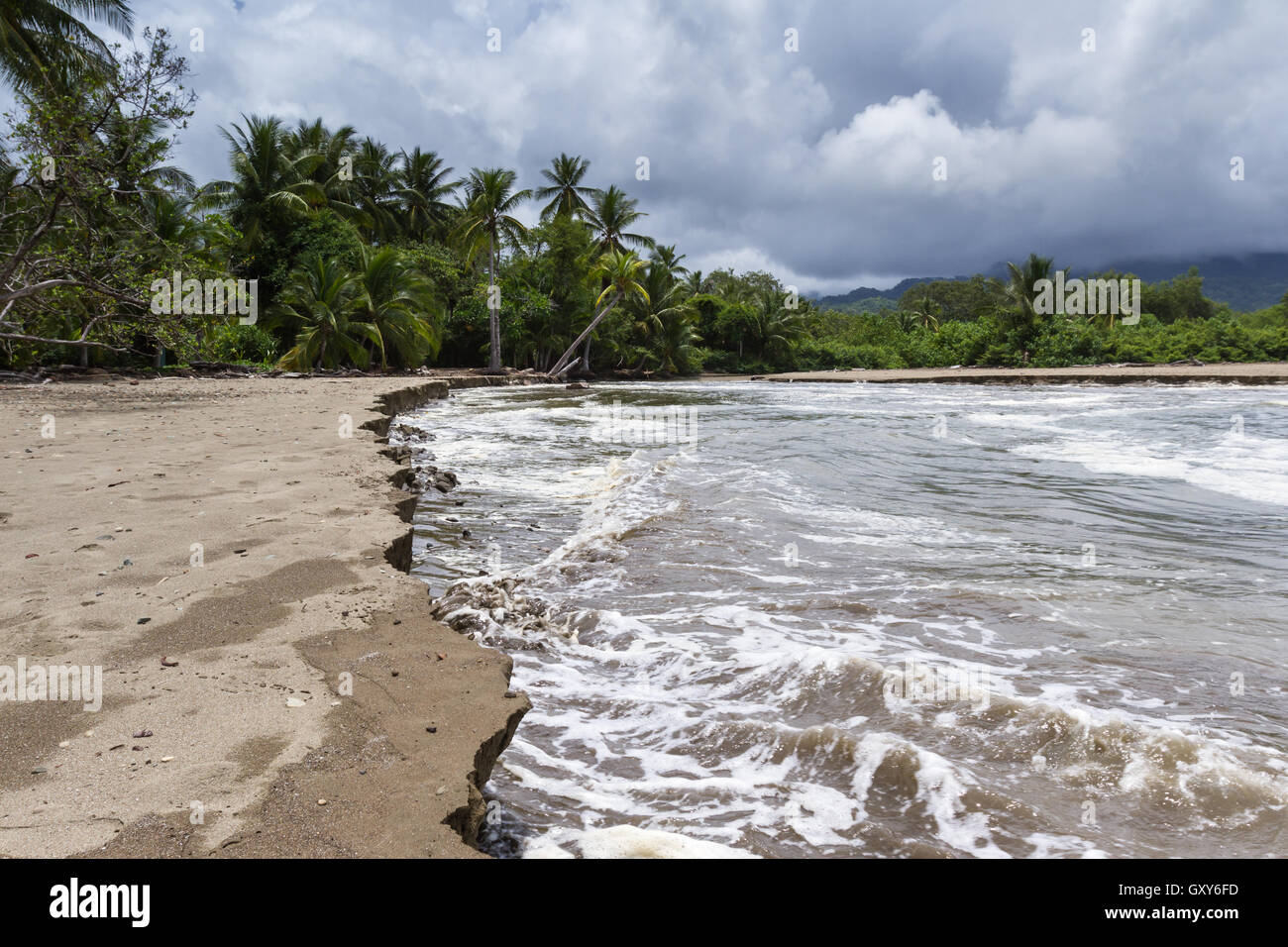 small river merging with the pacific ocean in the Costa Rican south ...