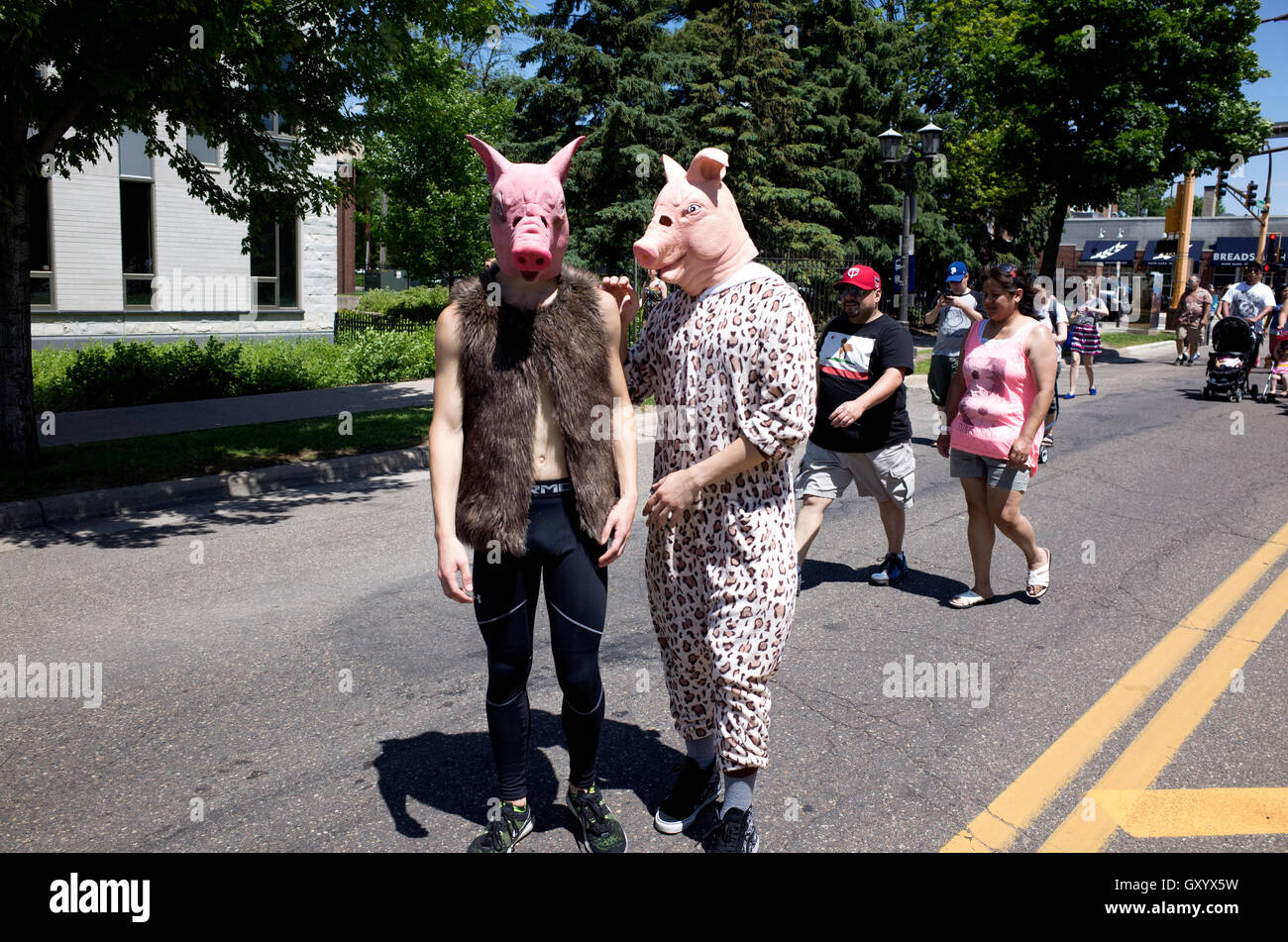 Two men in pig pull over masks strolling along the street at the Grand ...