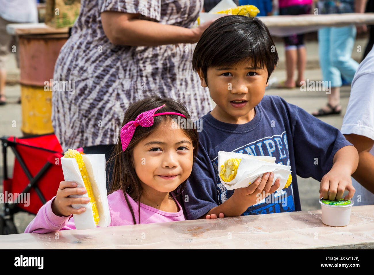 Children eating free corn at the Corn and Apple Festival in Morden ...