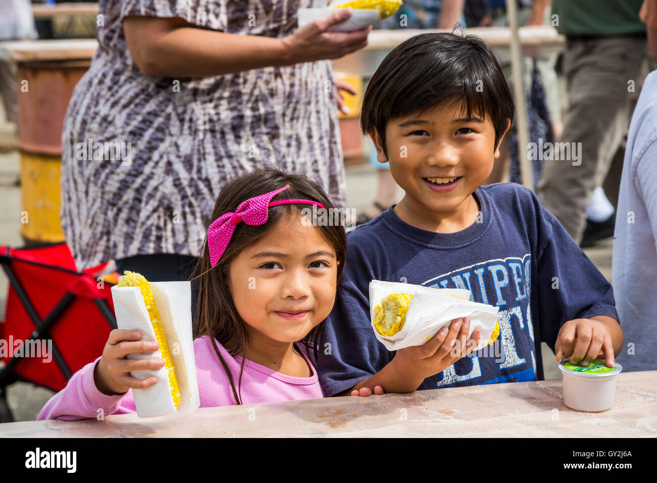 Children eating free corn at the Corn and Apple Festival in Morden ...