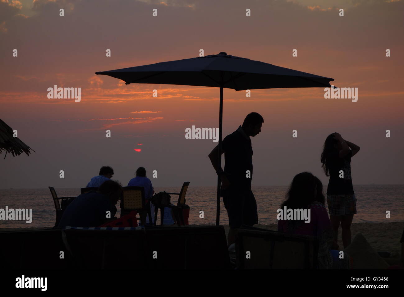 sunset on the beach with people Stock Photo - Alamy