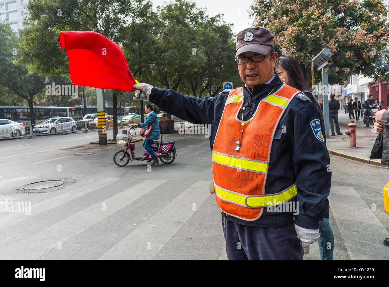 Chinese Traffic Warden is working at intersection in Xian, Shaanxi ...