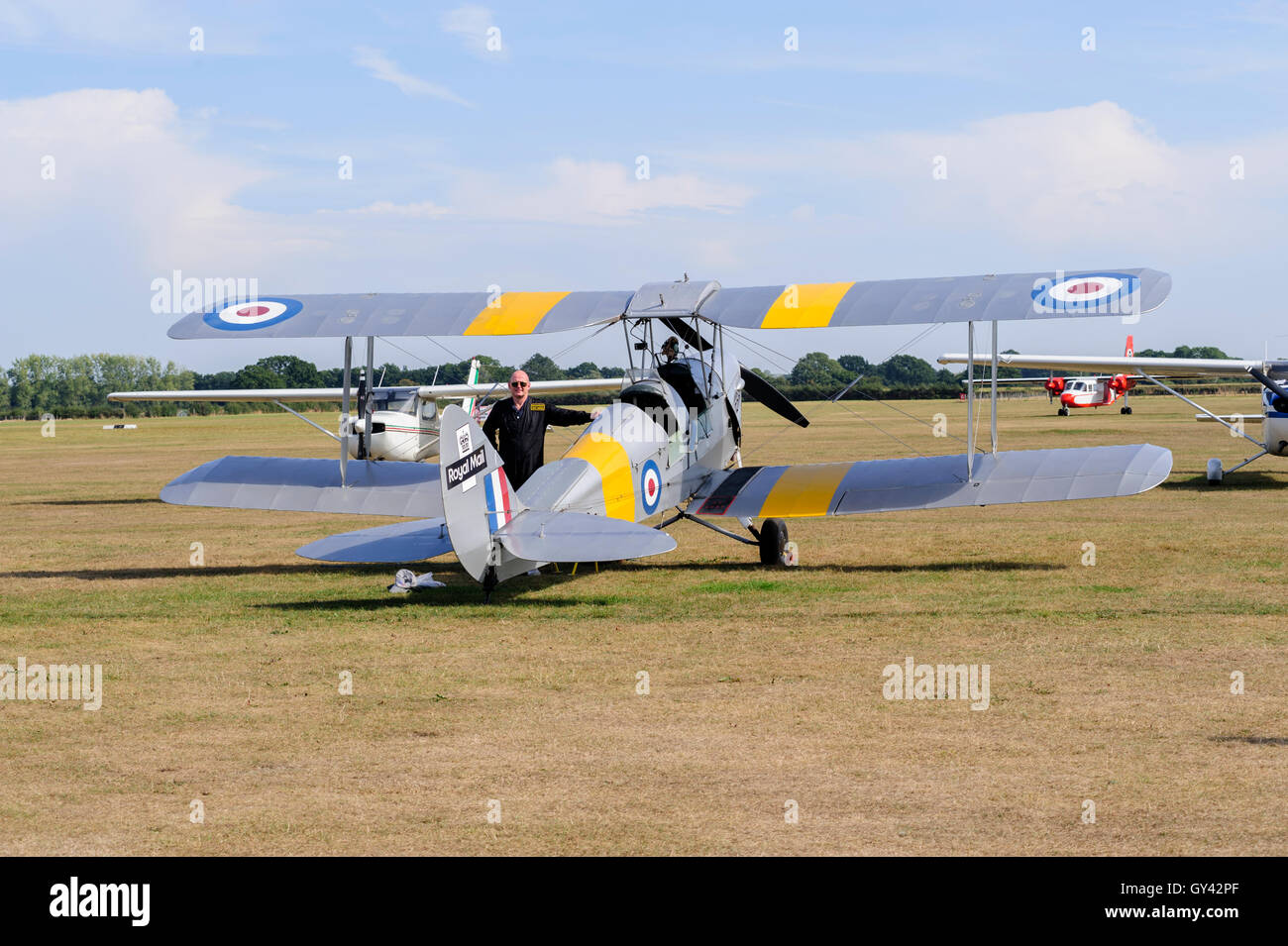 male pilot with vintage tiger moth aircraft at headcorn airfield in ...