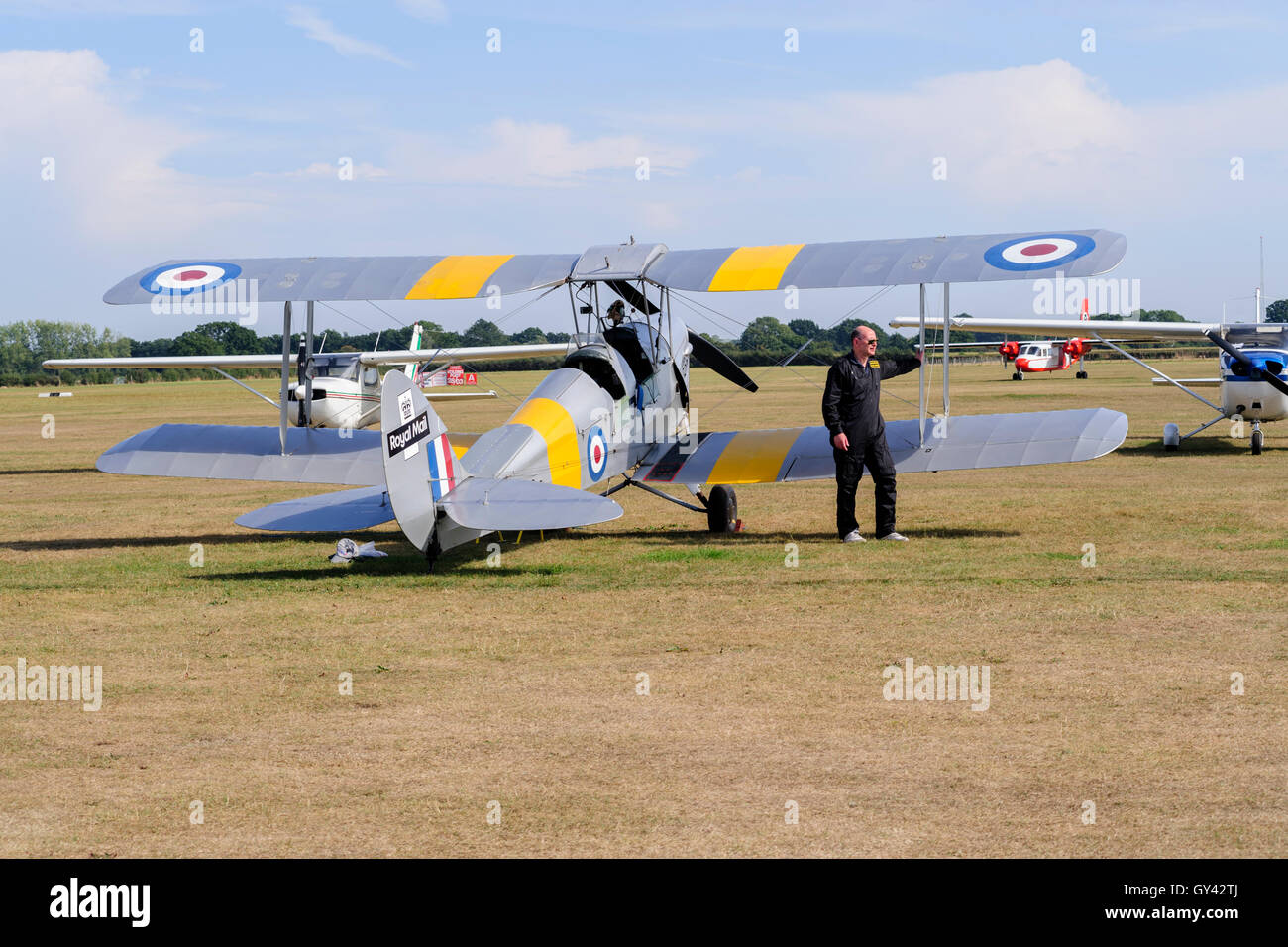 male pilot with vintage tiger moth aircraft at headcorn airfield in ...