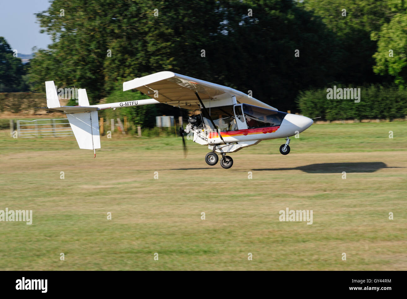 small microlight type of aircraft taking off at headcorn airfield in ...