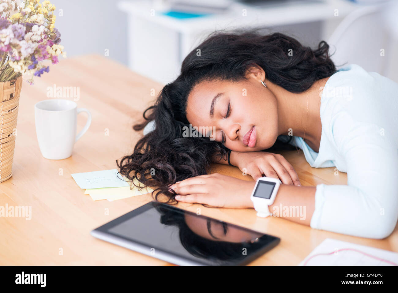 Pleasant tired woman sleeping on the table Stock Photo - Alamy