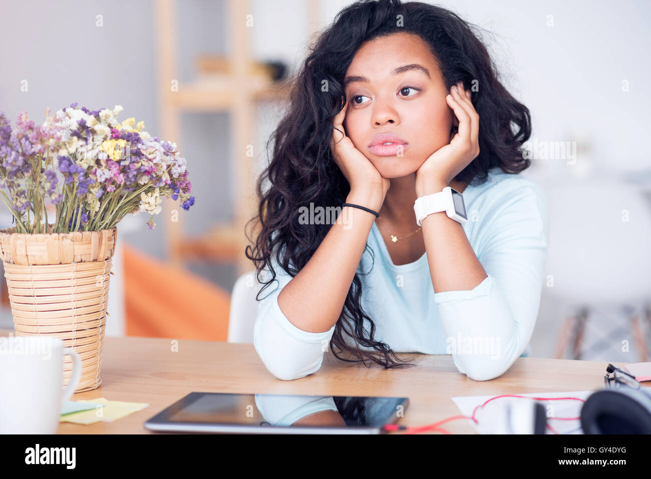 Tired woman sitting at the table Stock Photo - Alamy