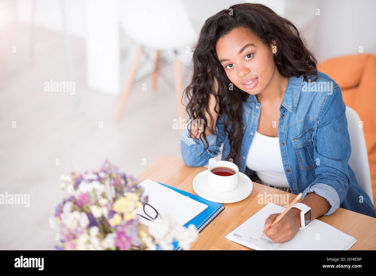 Pleasant beautiful woman sitting at the table Stock Photo - Alamy