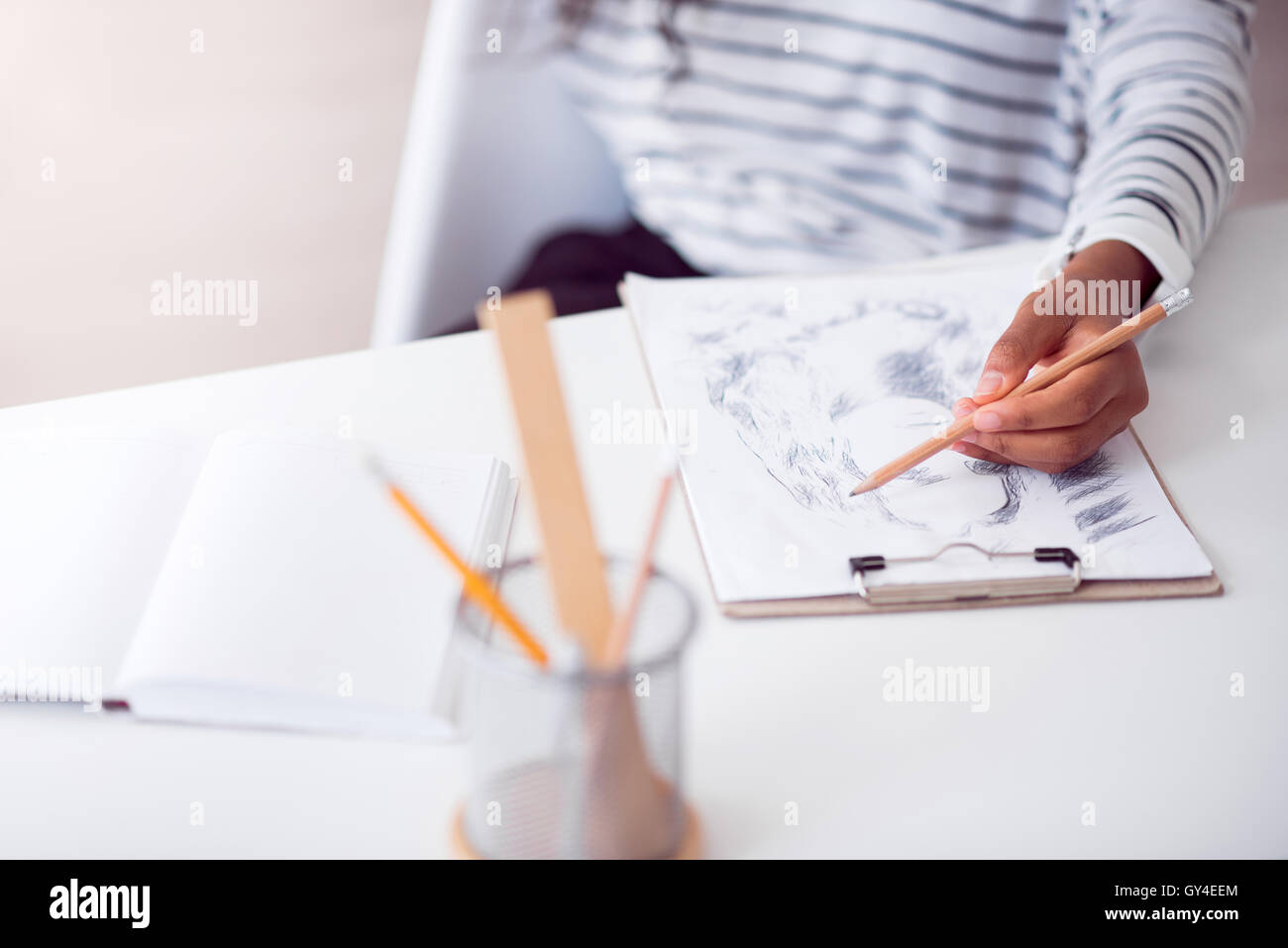 Pleasant woman drawing a portrait Stock Photo - Alamy