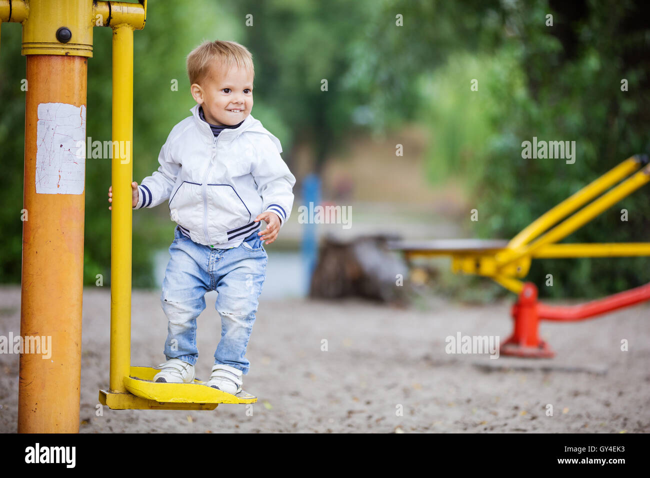 Child standing alone in playground hi-res stock photography and images ...