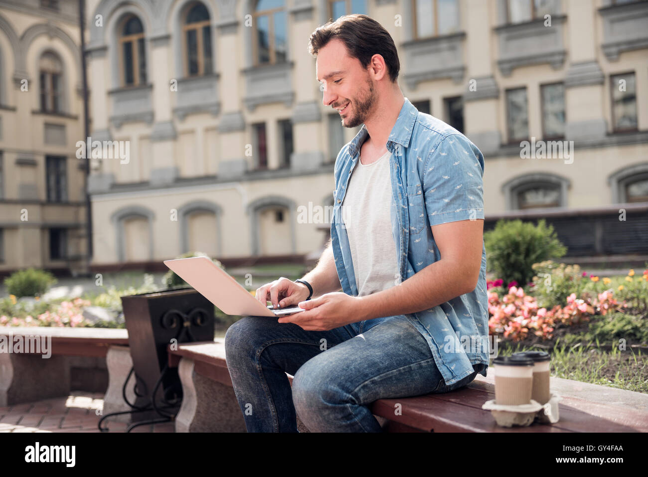 Handsome young man using laptop Stock Photo - Alamy