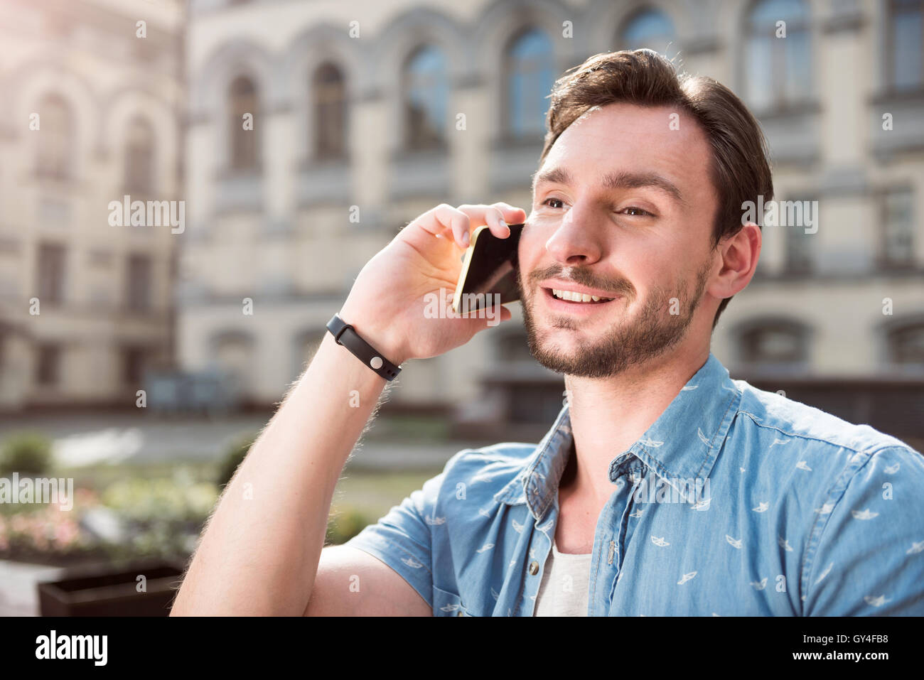 Attractive young man using phone Stock Photo - Alamy