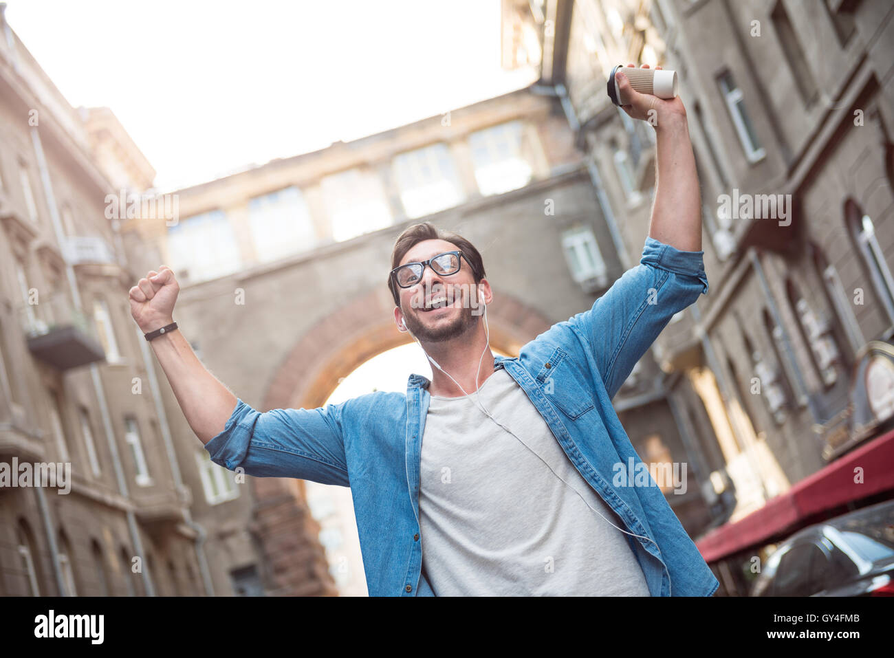 Happy man holding his hands up Stock Photo - Alamy