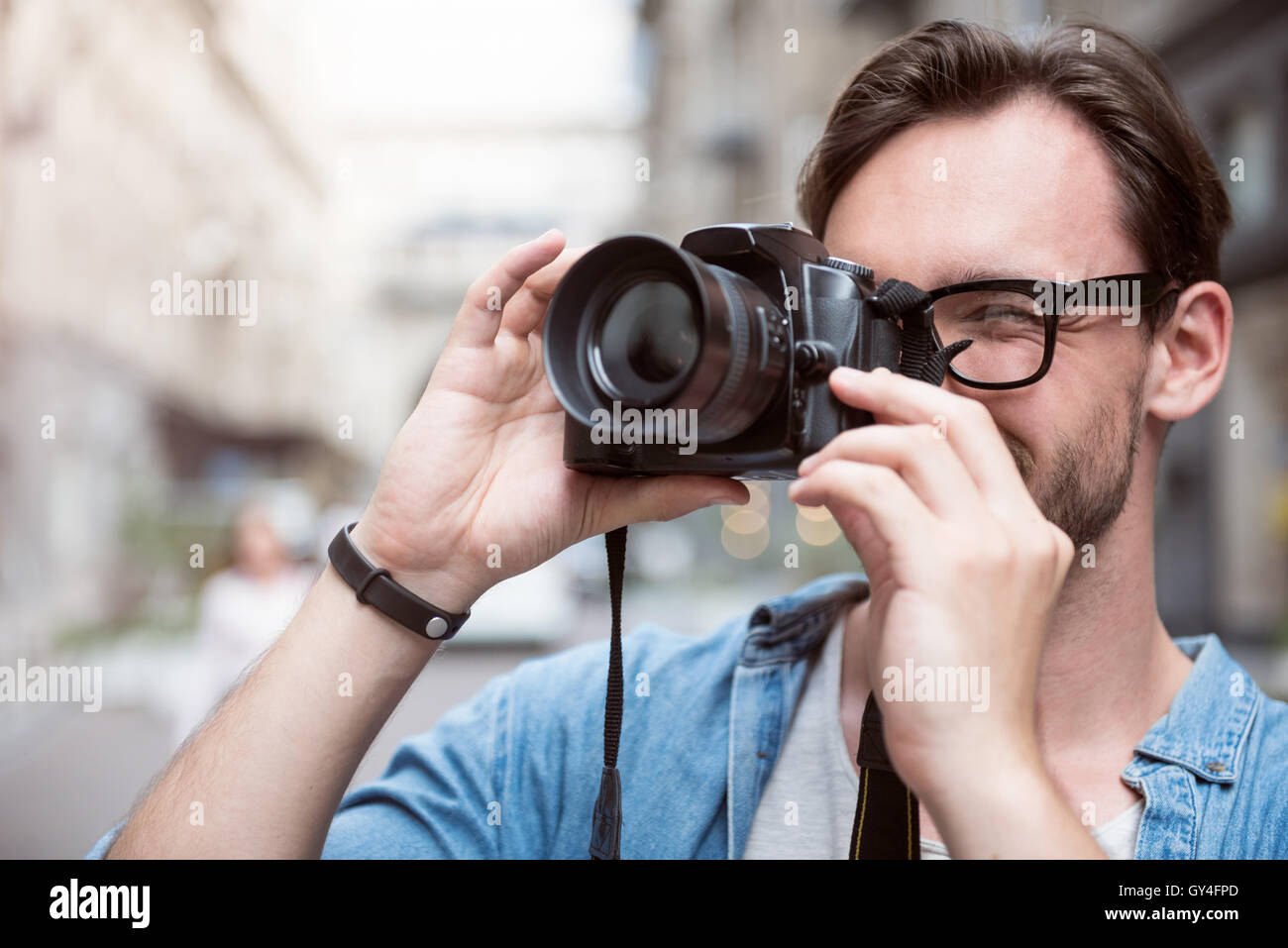 Handsome young man making photos Stock Photo - Alamy