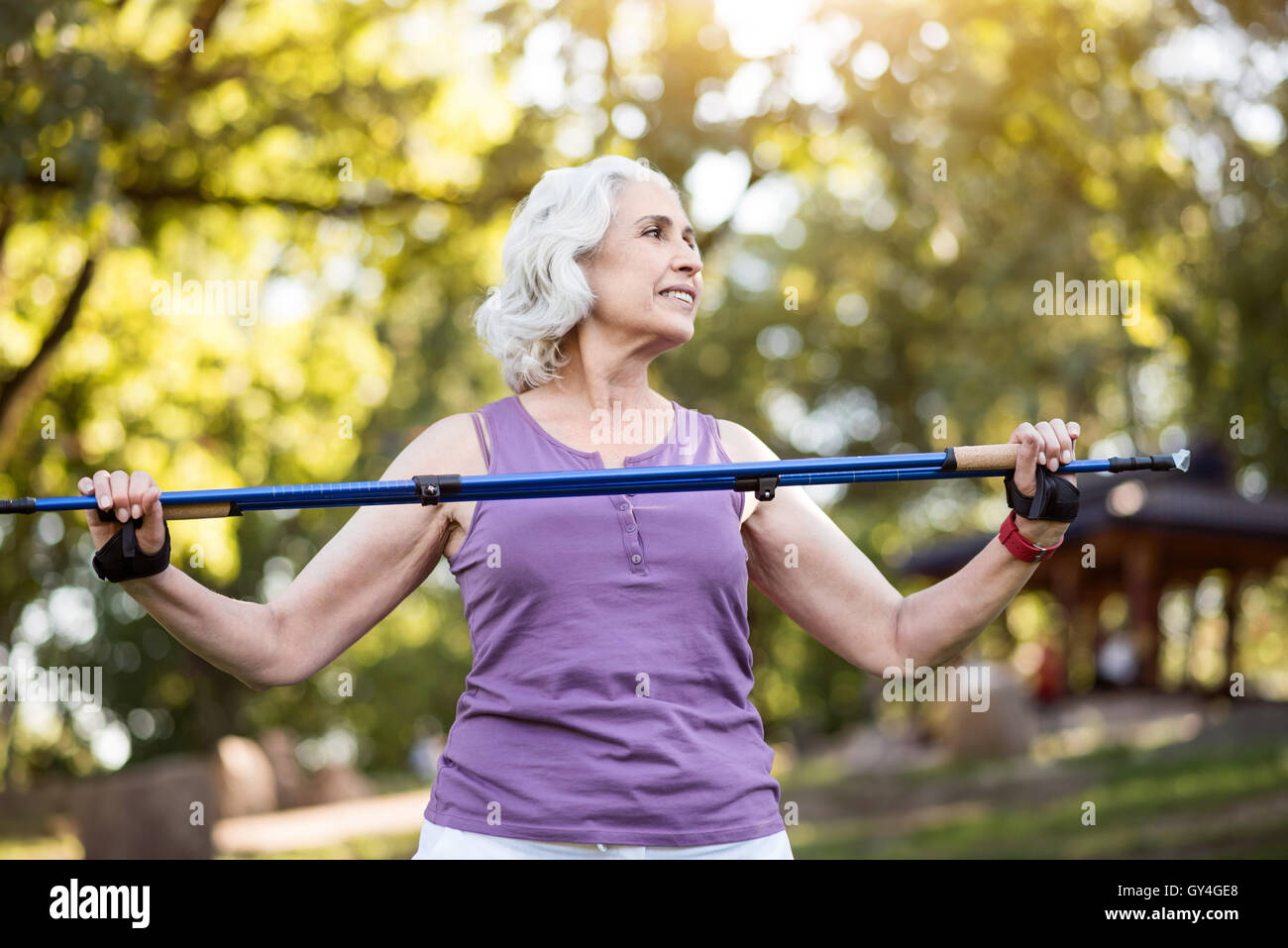 Grandma doing physical exercises with sprinter stick Stock Photo - Alamy