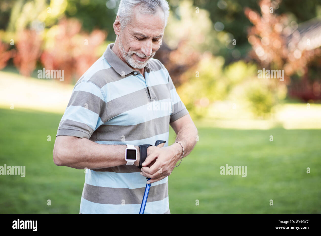 Positive old man fixing his sport glove Stock Photo - Alamy