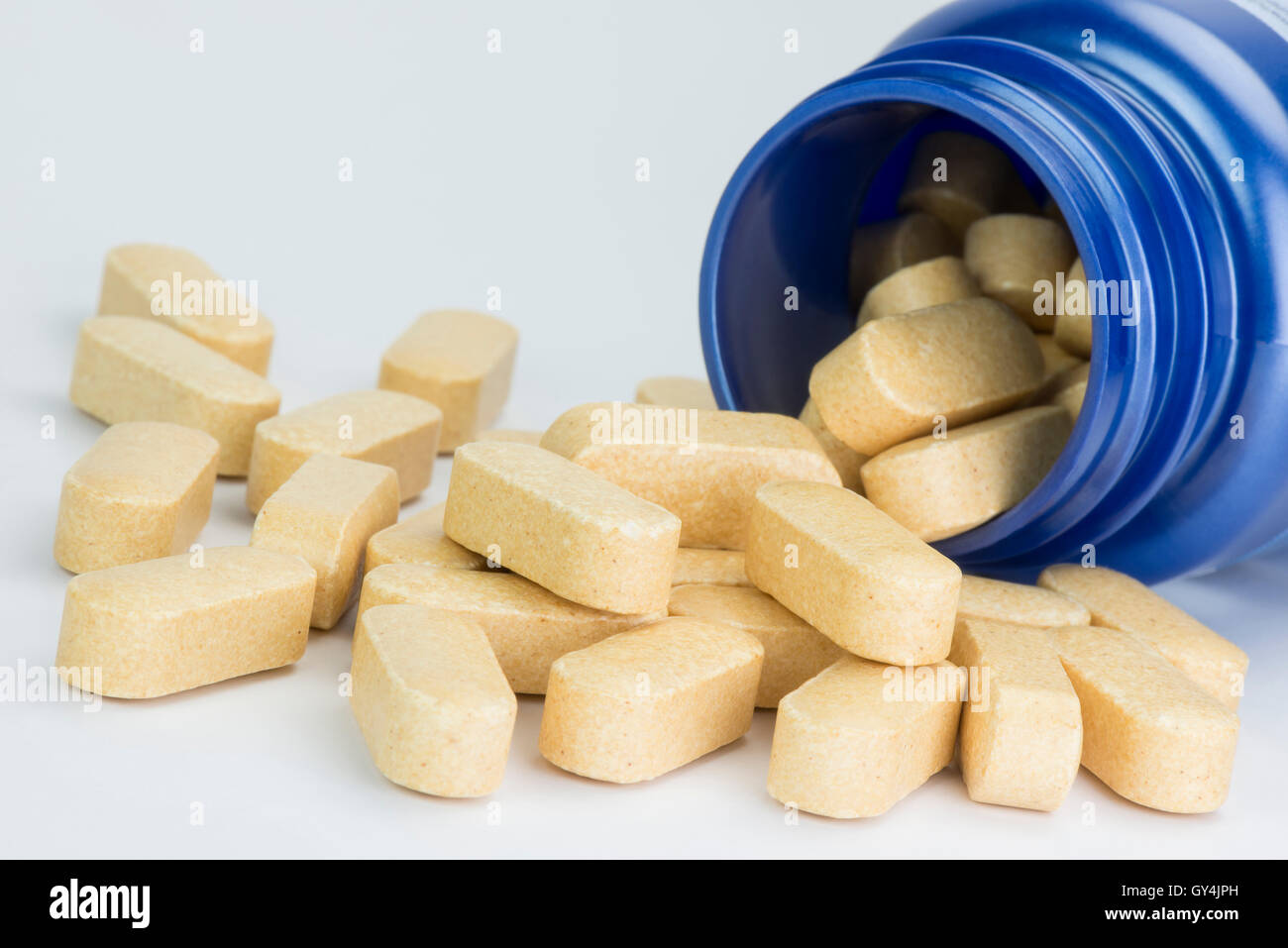 Collection yellow tablets from a fallen blue medicine jar Stock Photo ...