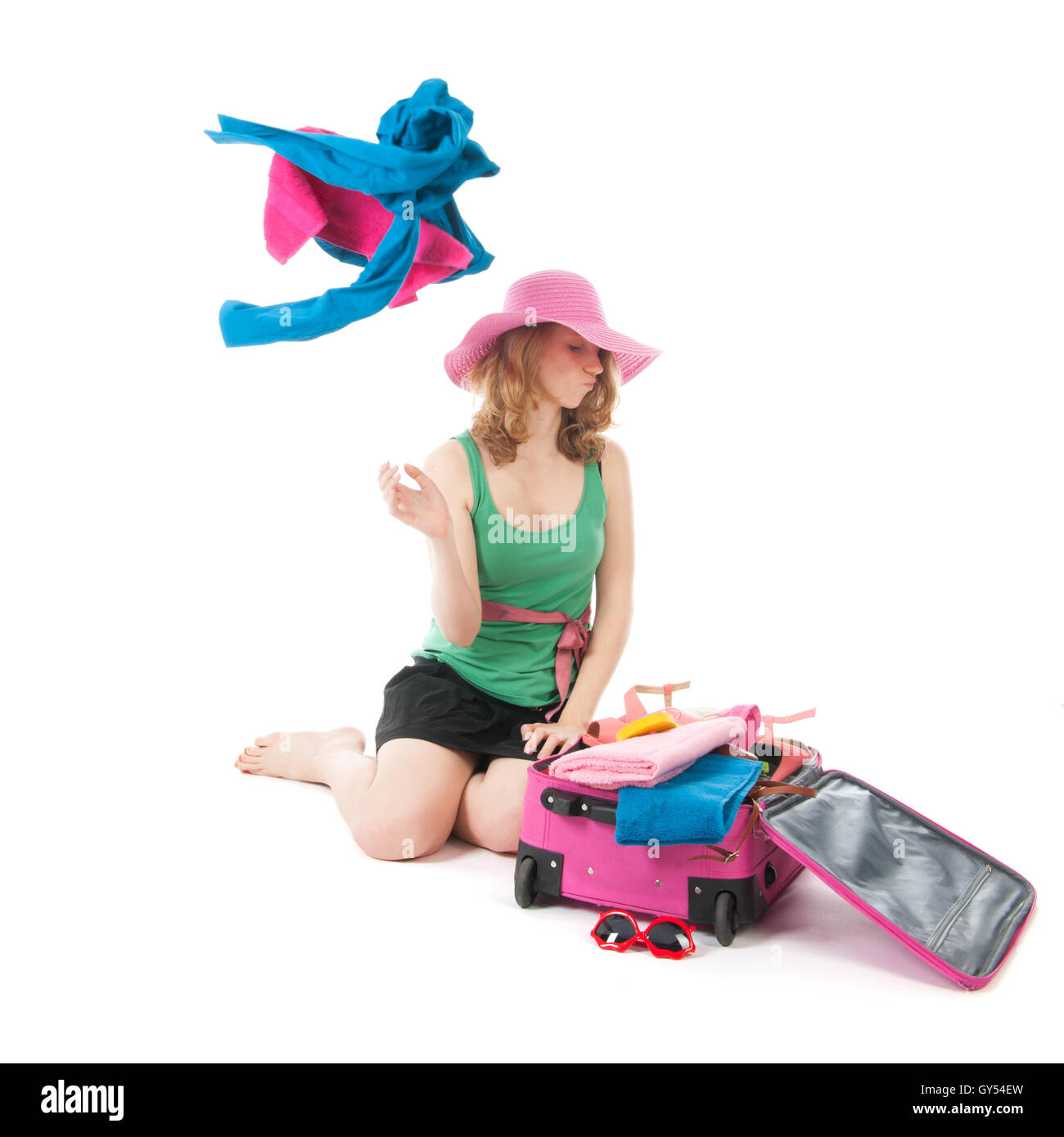 Packing the suitcase by a young woman Stock Photo - Alamy