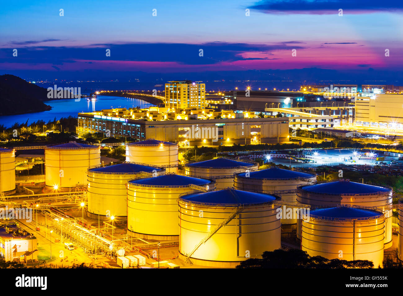 Oil tanks plant during sunset Stock Photo - Alamy
