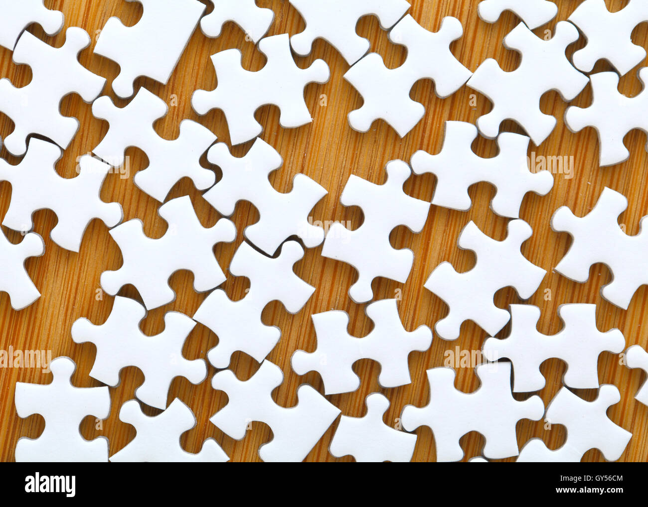 Puzzle pieces with wooden background Stock Photo - Alamy