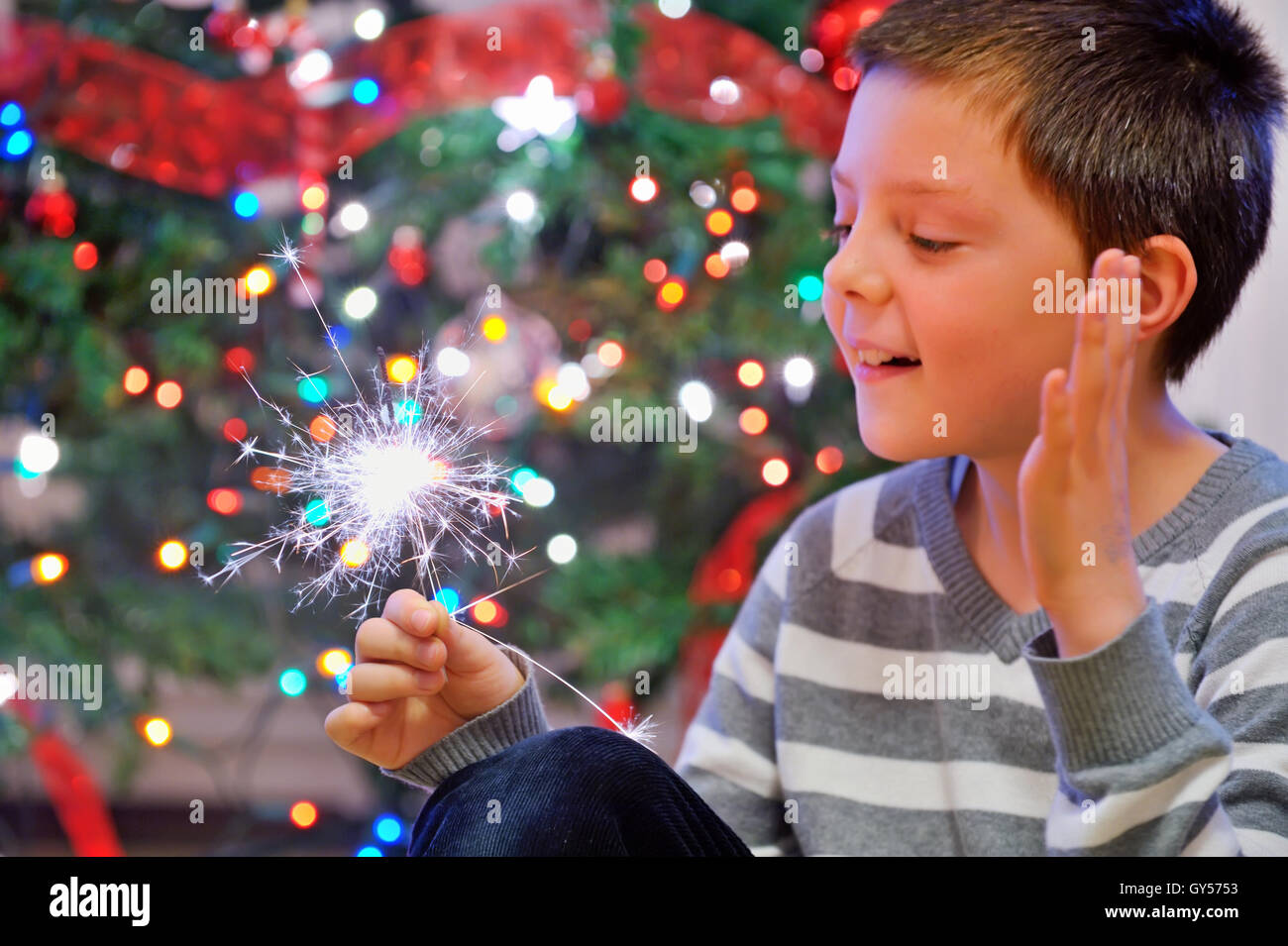 portrait of boy looking at fire sparks Stock Photo - Alamy