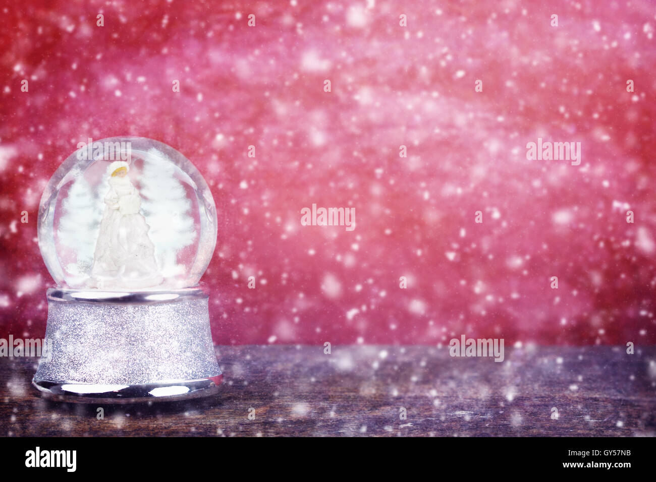 Snowglobe Against Red Stock Photo - Alamy