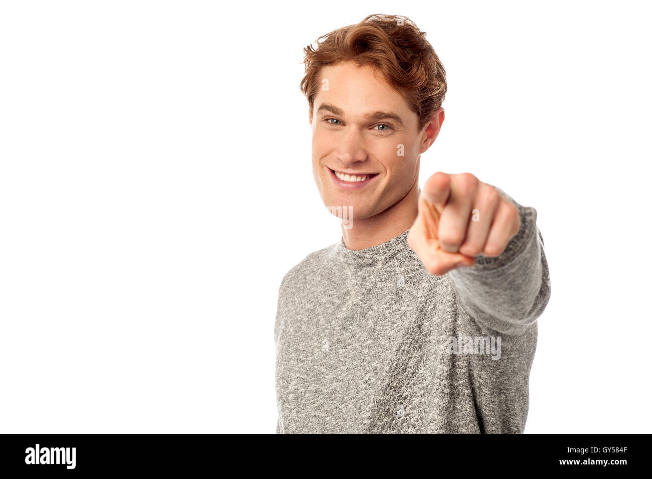 Young smiling guy pointing you out Stock Photo - Alamy