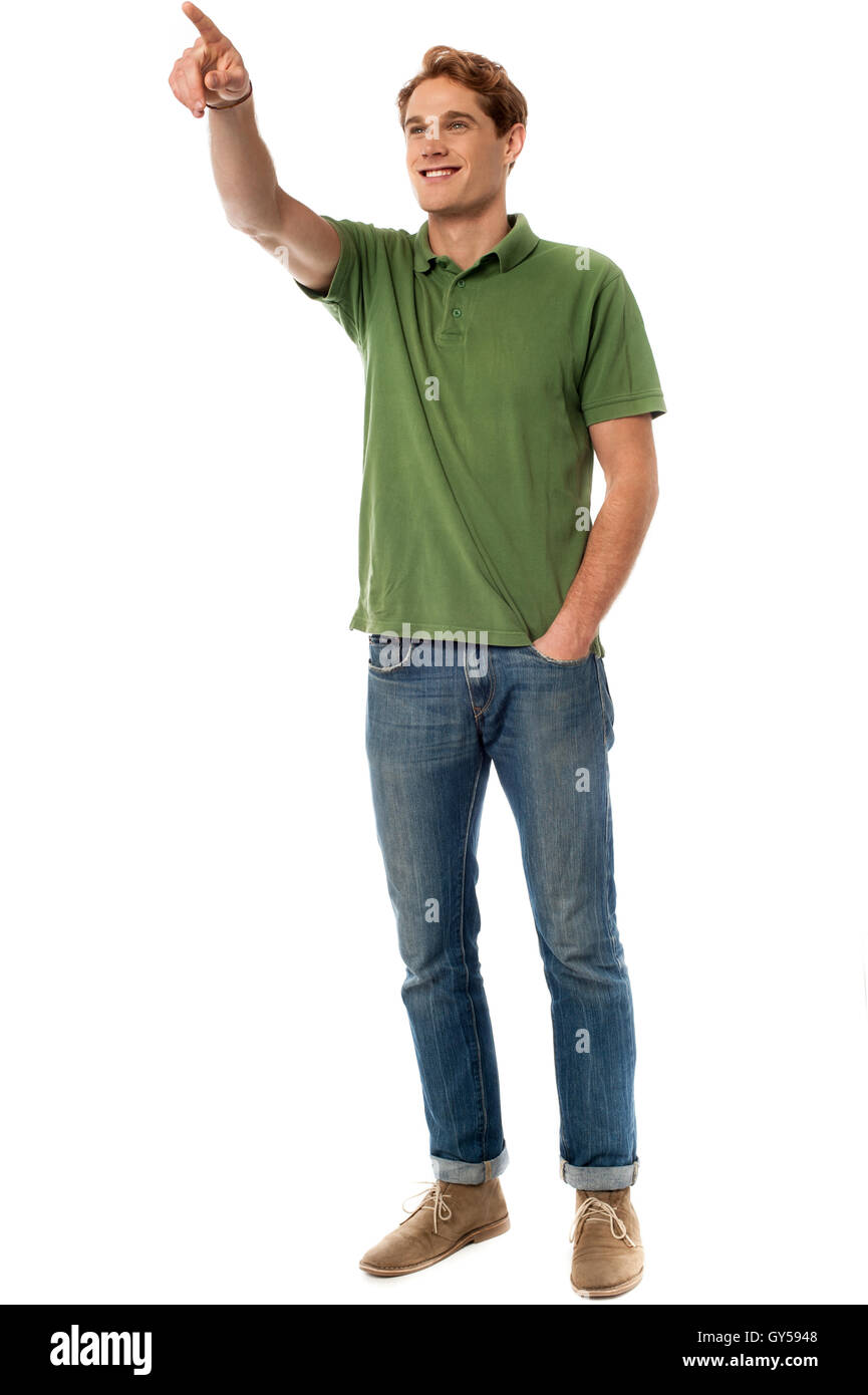 Casual young man pointing at something Stock Photo - Alamy