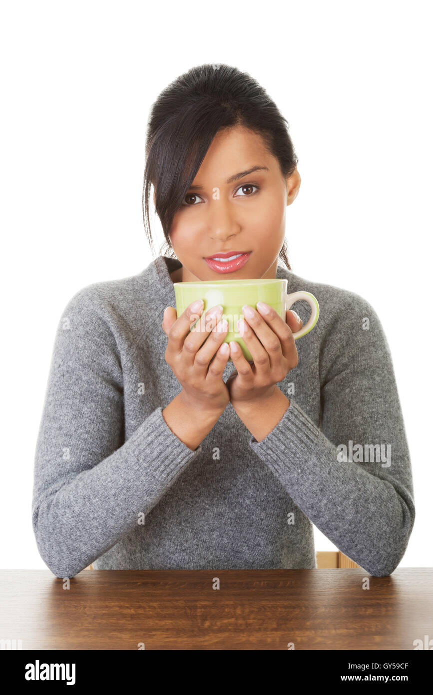 Young woman drinking something from big mug Stock Photo - Alamy
