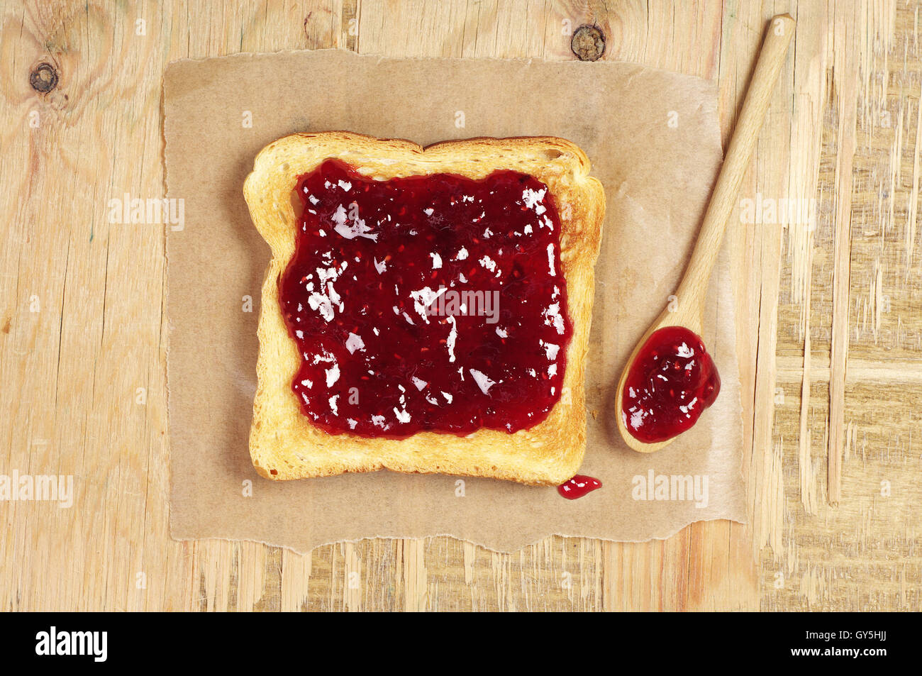 Toast bread with jam on old wooden table. Top view Stock Photo - Alamy