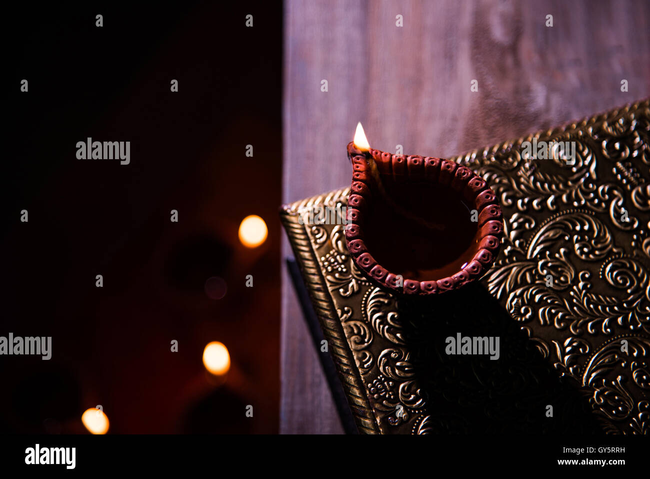 beautiful diwali diya with fire crackers and sweet pera, selective ...