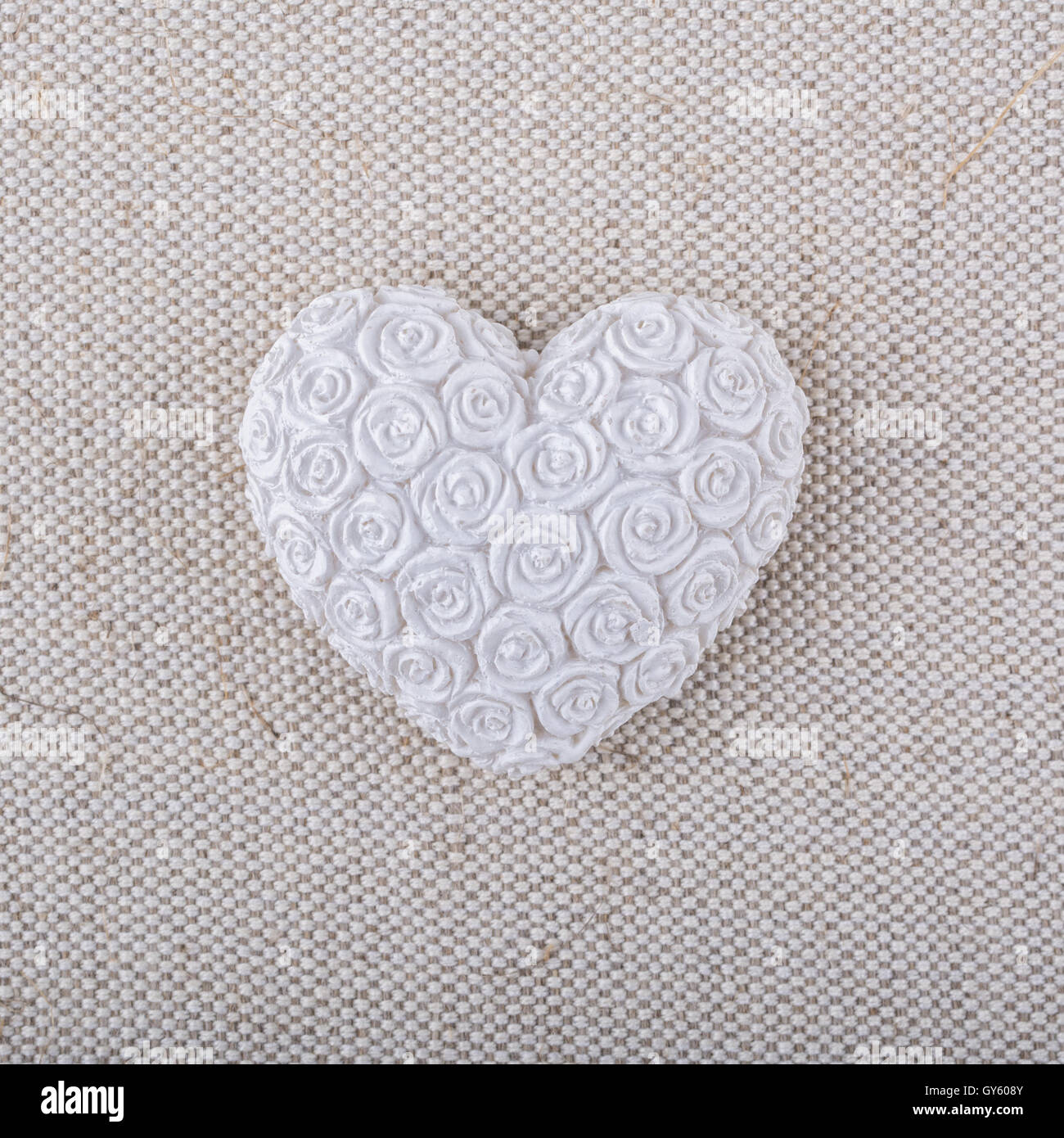 White heart on a beige fabric Stock Photo - Alamy